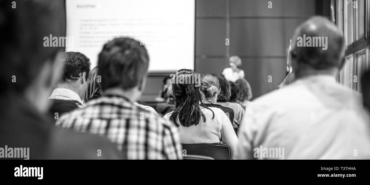 Woman giving presentation on business conference Stock Photo - Alamy