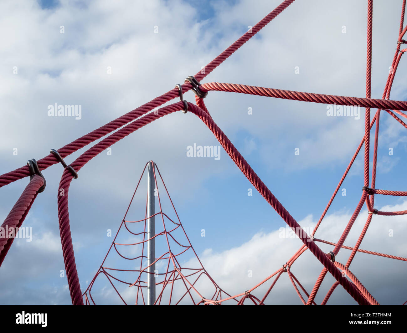 Children's playground red rope climbing structure with silver pole ...