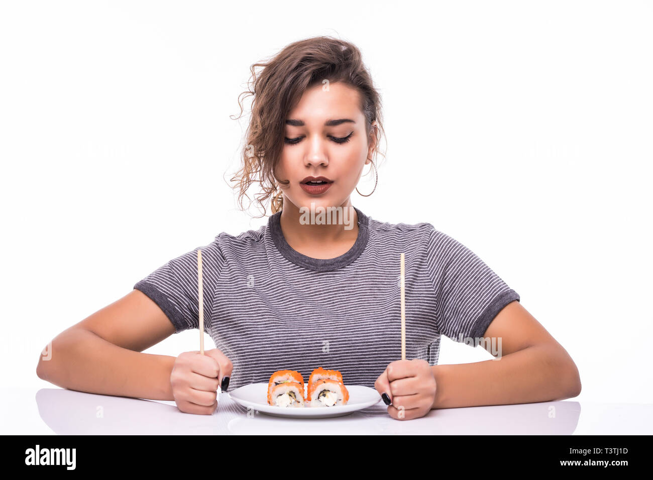 beautiful woman holding sushi with chopsticks, isolated on white ...