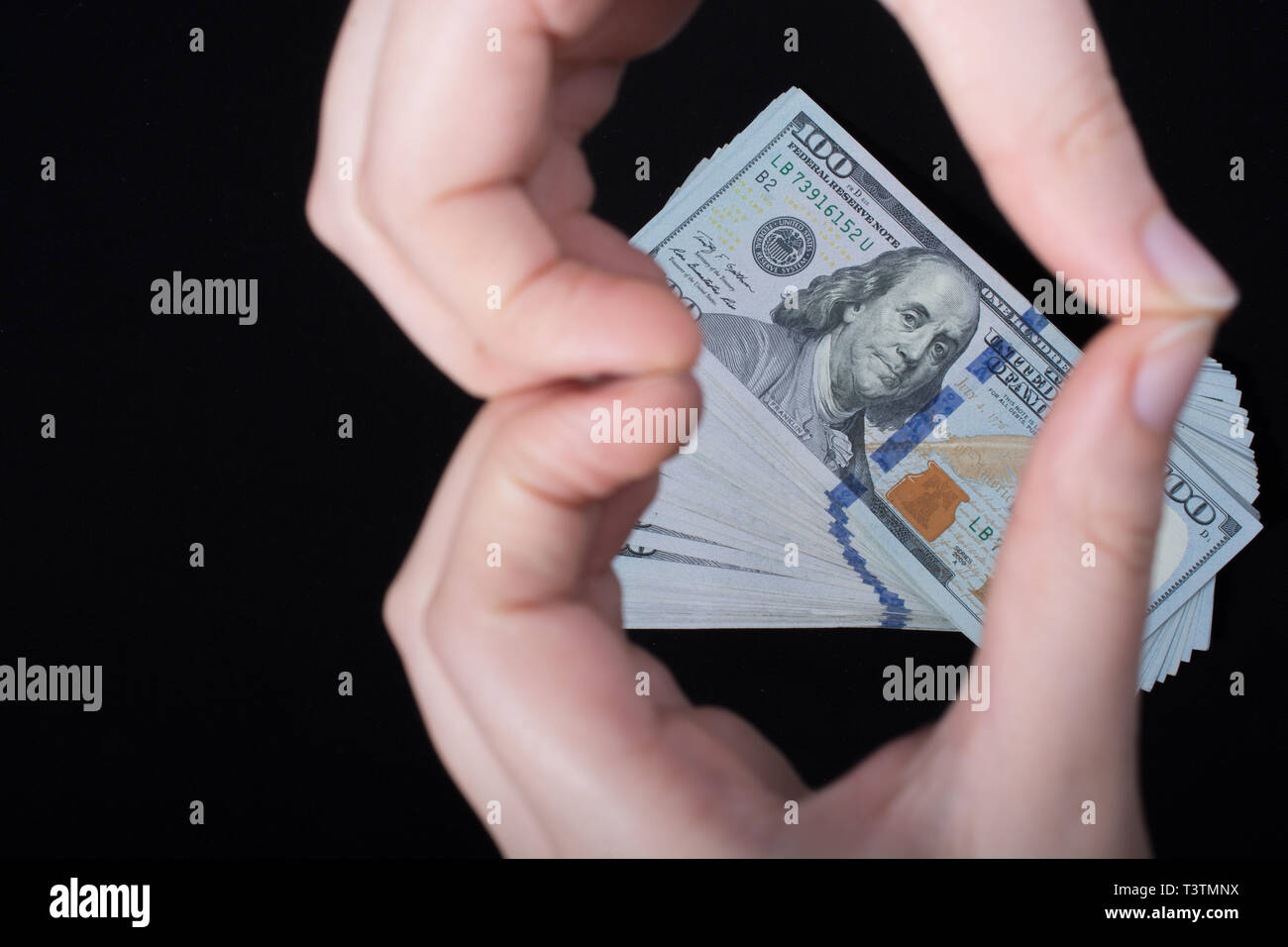 Hand holding American dollar banknotes isolated on white background ...