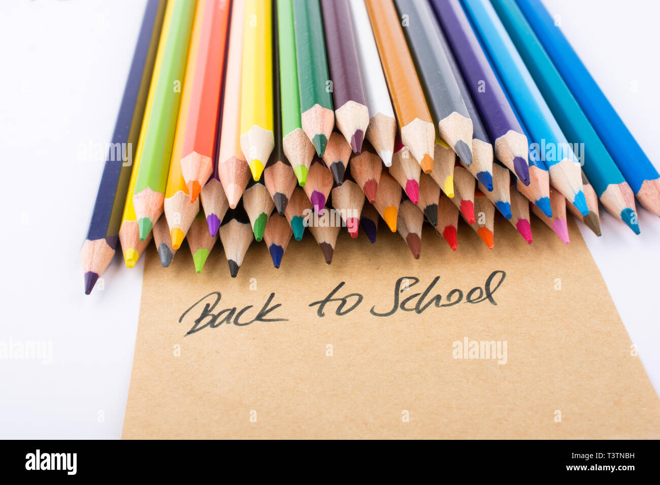 Color pencils and back to school title on a notebook Stock Photo - Alamy
