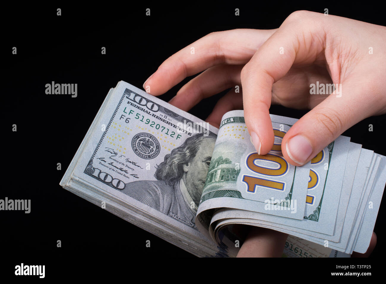 Hand holding American dollar banknotes isolated on white background ...