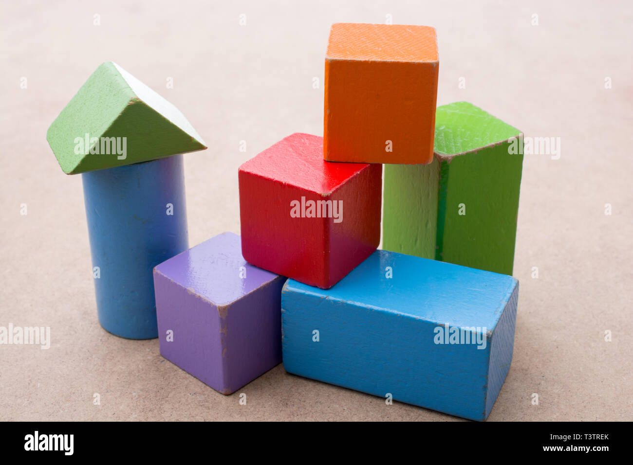 Colorful building blocks on a brown background Stock Photo - Alamy