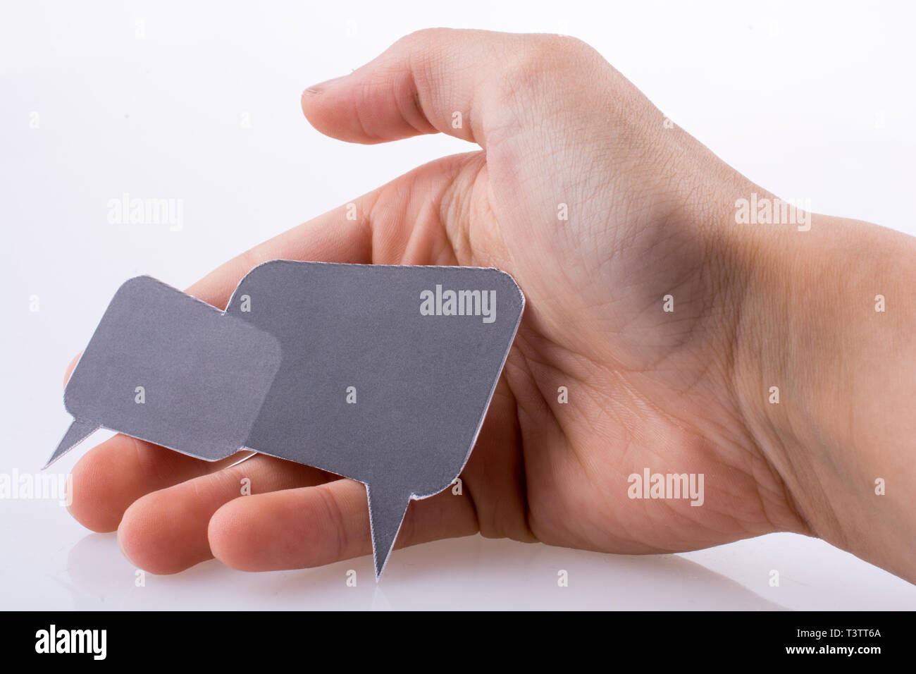 Hand holding dialogue boxes on a white background Stock Photo - Alamy