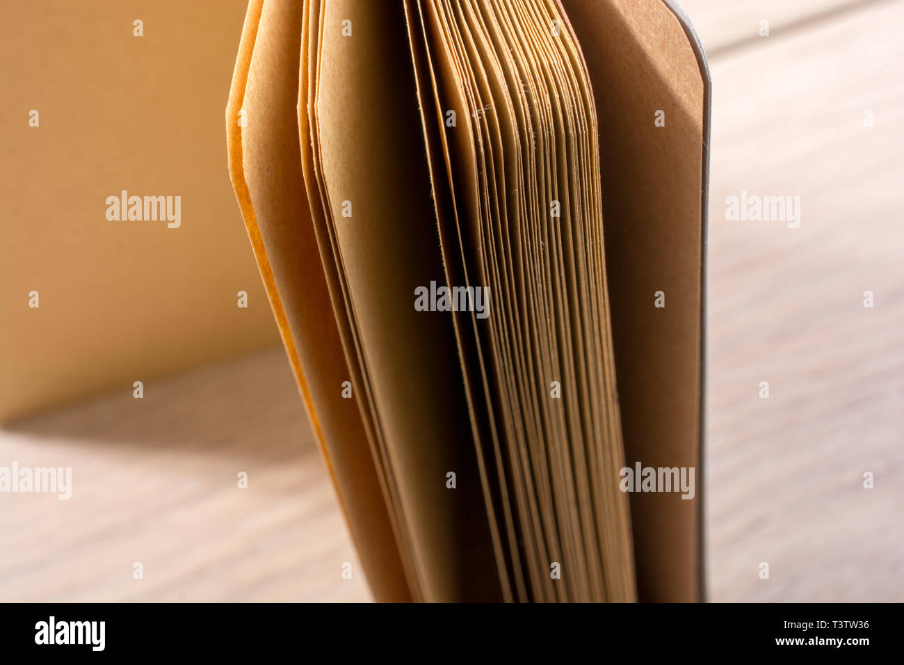 Brown color notebook open on a black background Stock Photo - Alamy