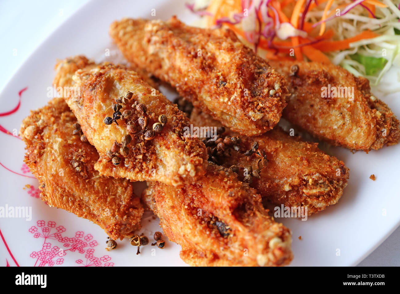 Plate of Northern Thai Deep Fried Chicken Wing with Hot and Spicy Herbs ...
