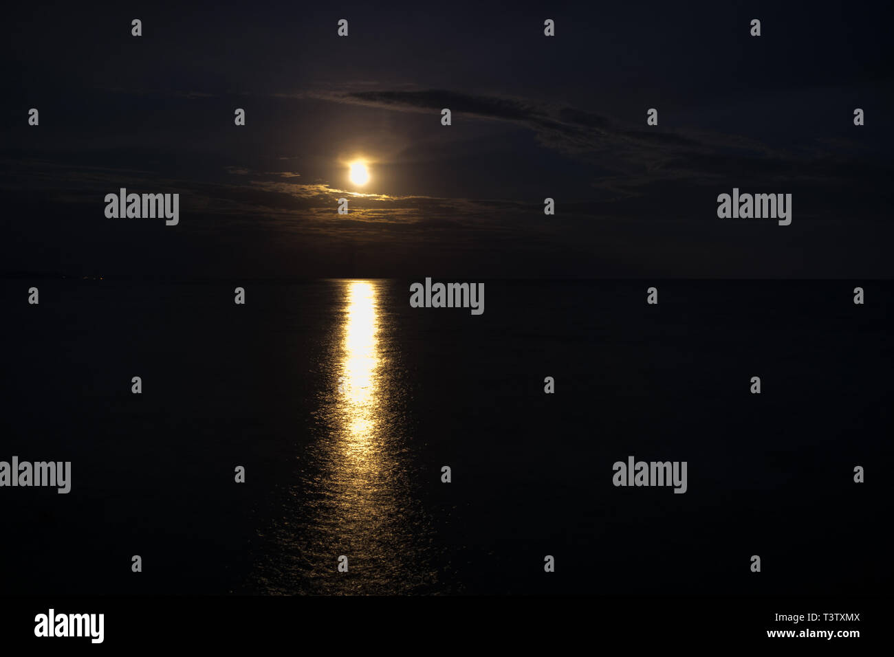 moon reflection over water against black background Stock Photo - Alamy
