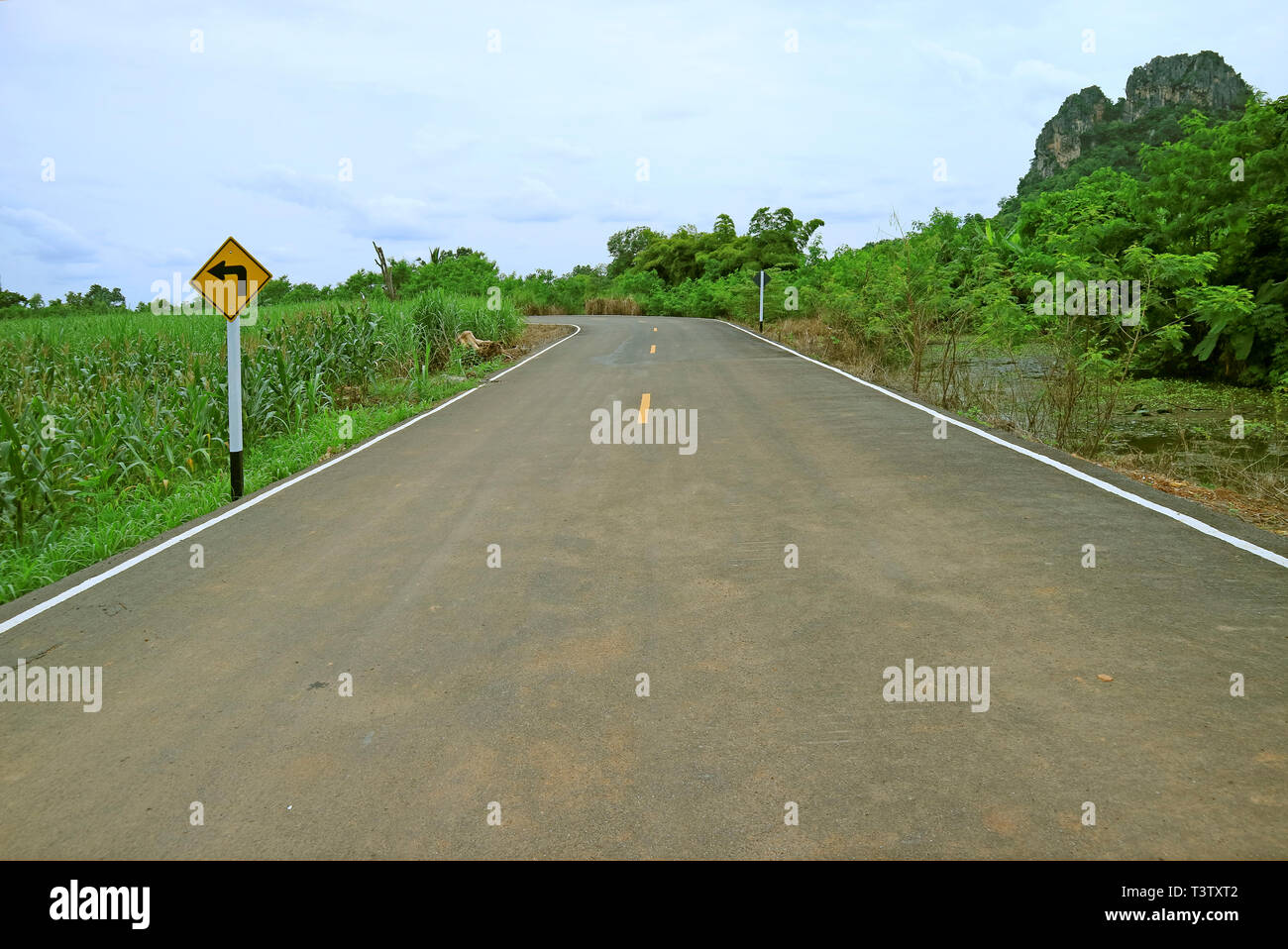 Left Turn Ahead Traffic Sign on the Country Roadside of Thailand Stock ...