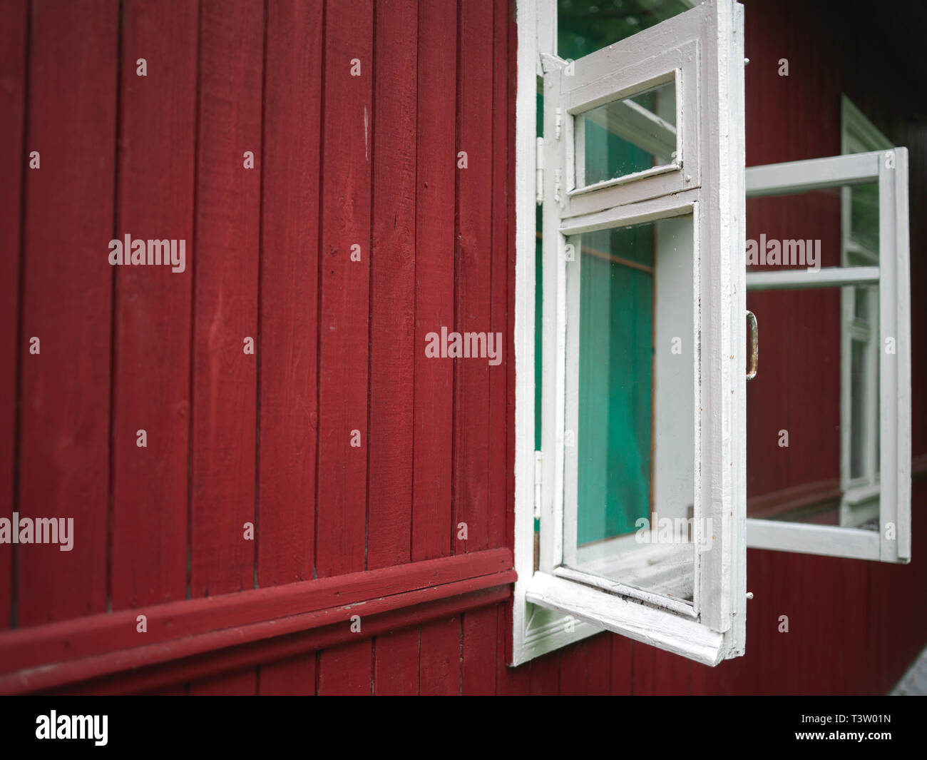 Wooden house painted in red with widely open windows Stock Photo - Alamy