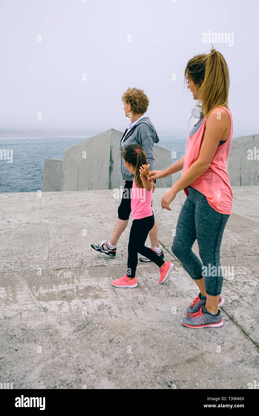 Three female generations walking Stock Photo - Alamy