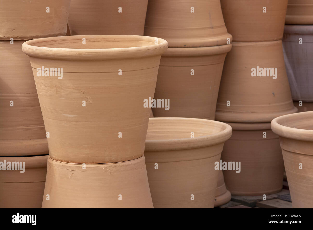 Rustic terracotta pots piled up on display closeup full frame Stock ...