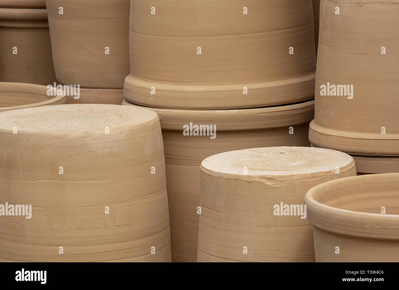 Rustic terracotta pots piled up on display closeup full frame Stock ...