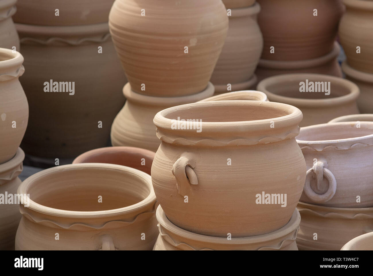 Rustic terracotta pots piled up on display closeup full frame Stock ...
