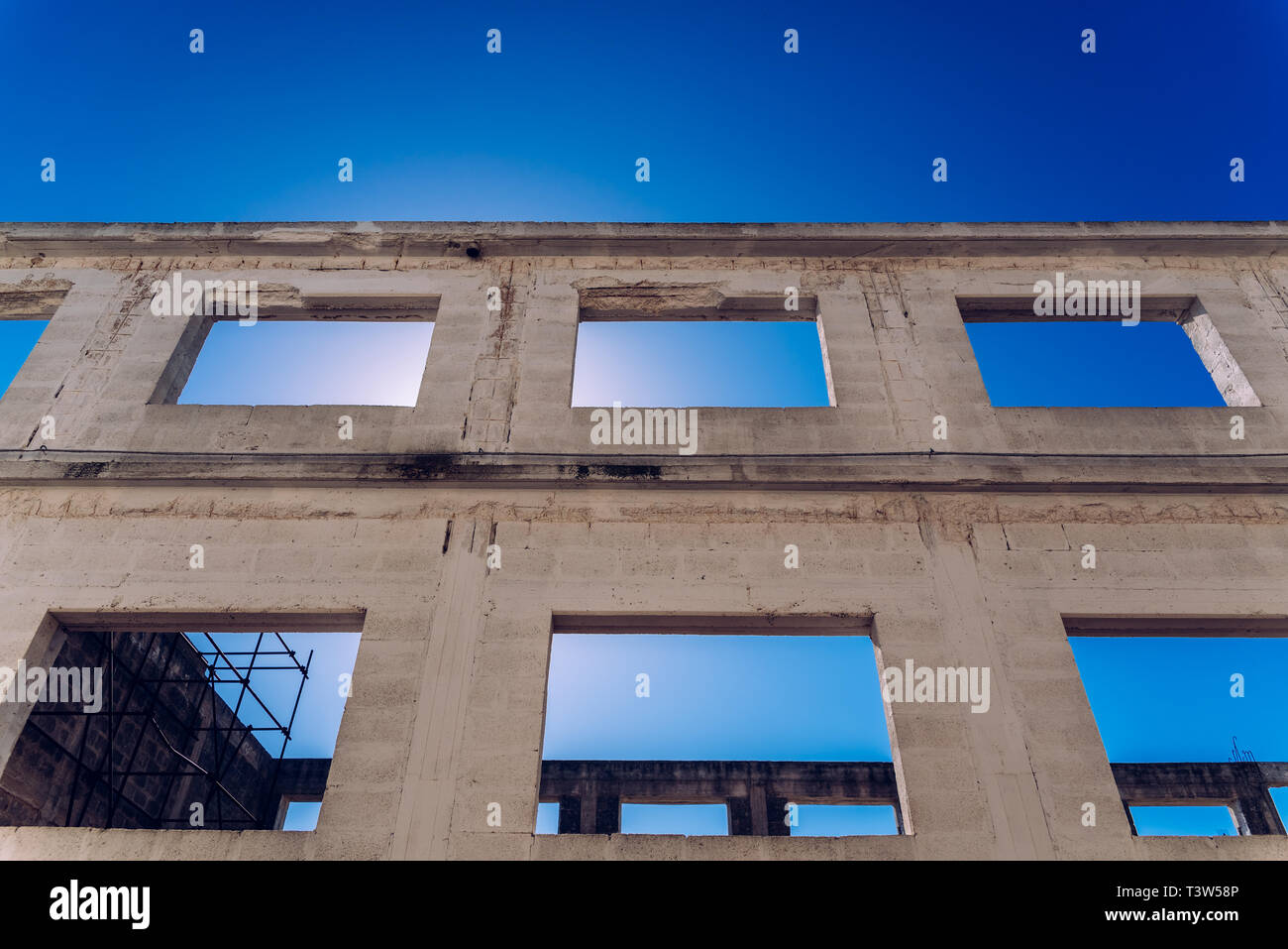 Window of abandoned building without finishing its construction ...