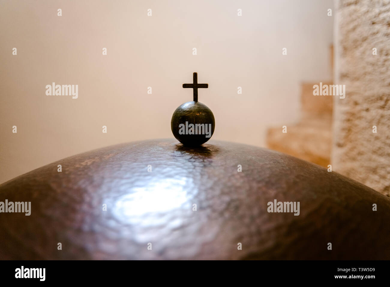 Christian cross on a small metal ball, negative space Stock Photo - Alamy
