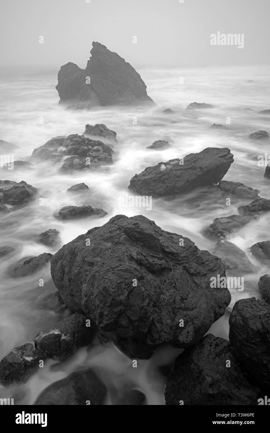 Sea water washing over black rocks hi-res stock photography and images ...