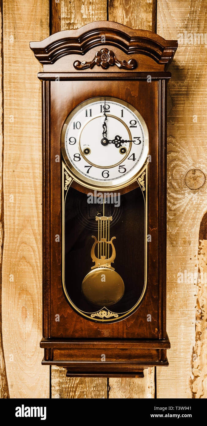 old and big clock hanging on a wooden wall Stock Photo - Alamy