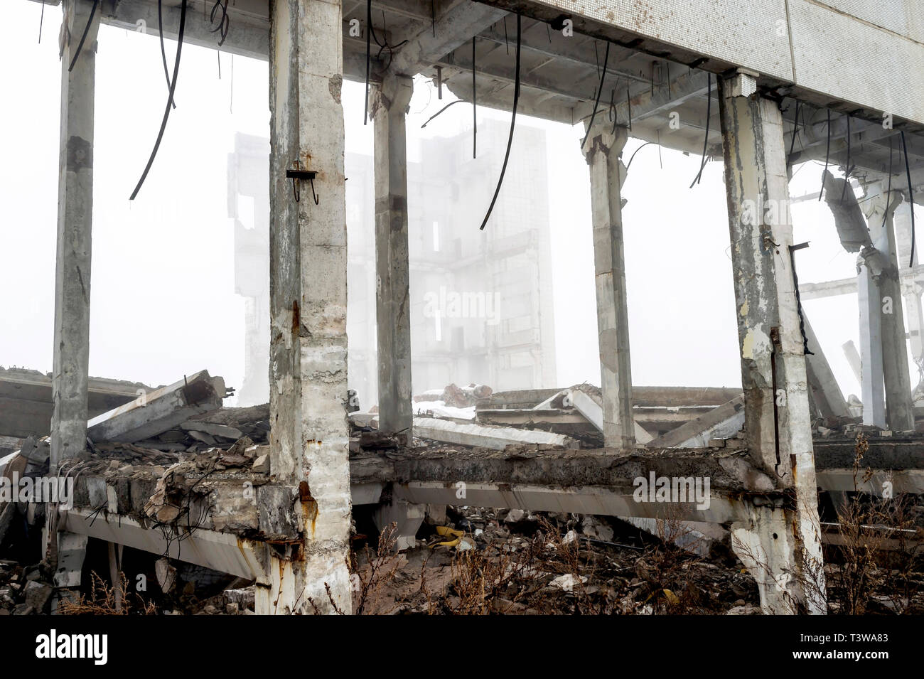 The remains of a large building destroyed in a foggy haze. Background ...
