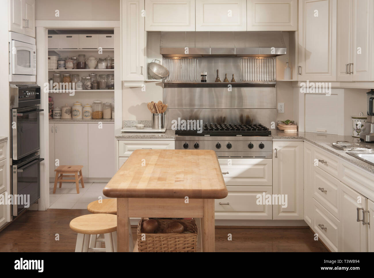 Wooden counter and stove in modern kitchen Stock Photo - Alamy