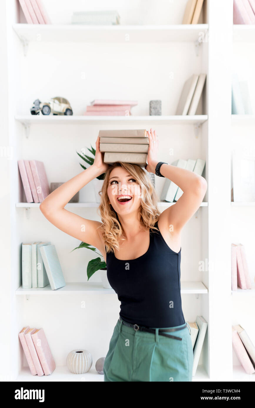 Woman balancing books head hi-res stock photography and images - Alamy