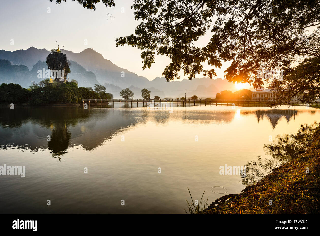 Mountains and bridge reflected in still lake, Hpa an, Kayin, Myanmar ...