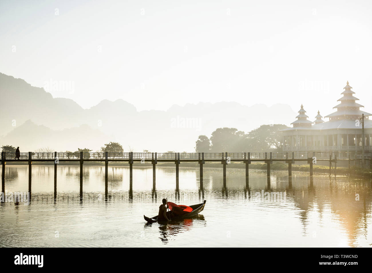 Mountains and bridge reflected in still lake, Hpa an, Kayin, Myanmar ...