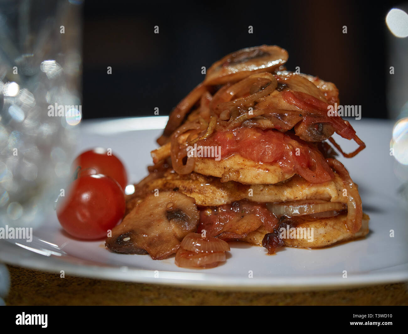 Small cuts of meat cooked along with fried mushrooms and onions are ...