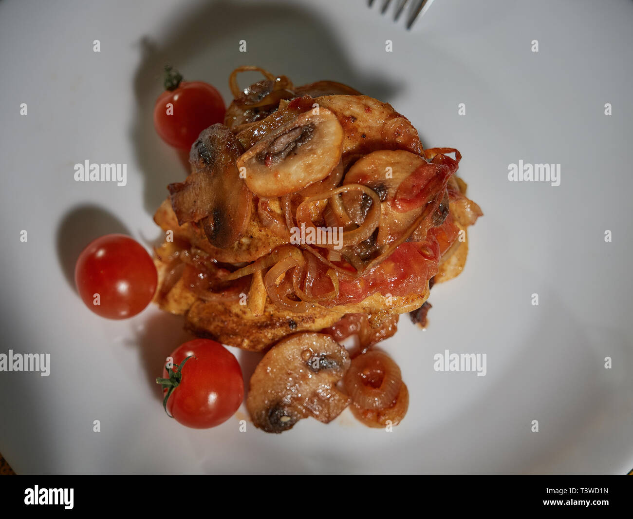 Small cuts of meat cooked along with fried mushrooms and onions are ...