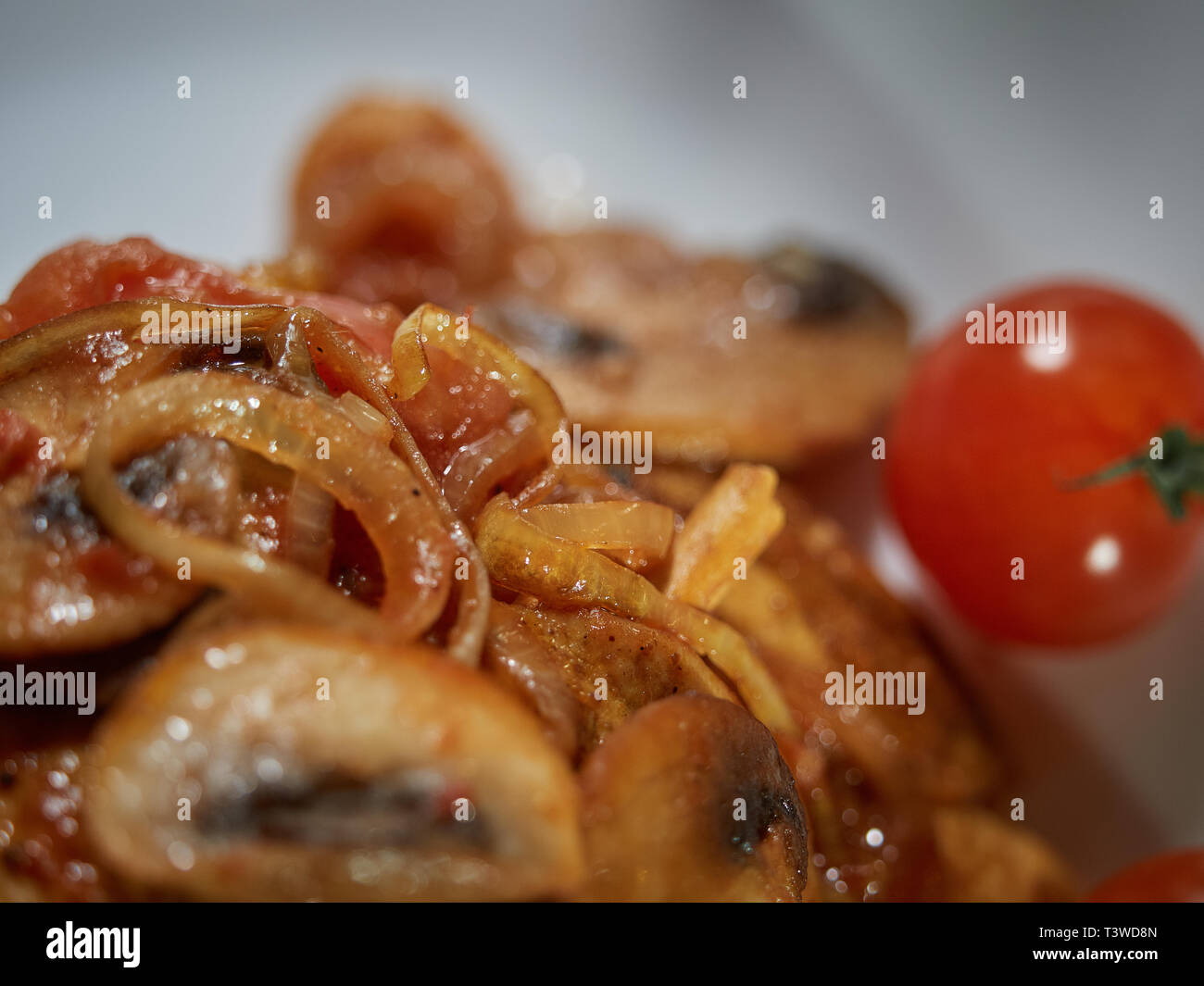 Small cuts of meat cooked along with fried mushrooms and onions are ...