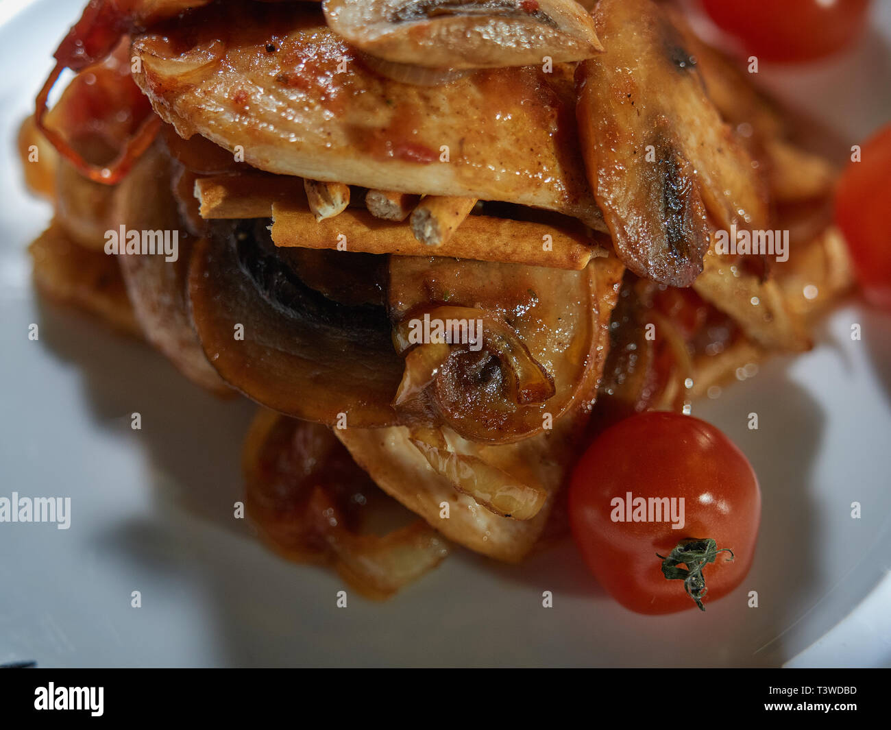 Small cuts of meat cooked along with fried mushrooms and onions are ...