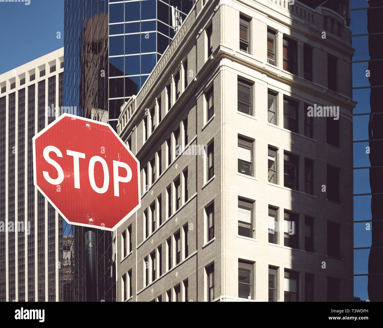 Stop sign on a street of New York City, color toned picture, selective ...