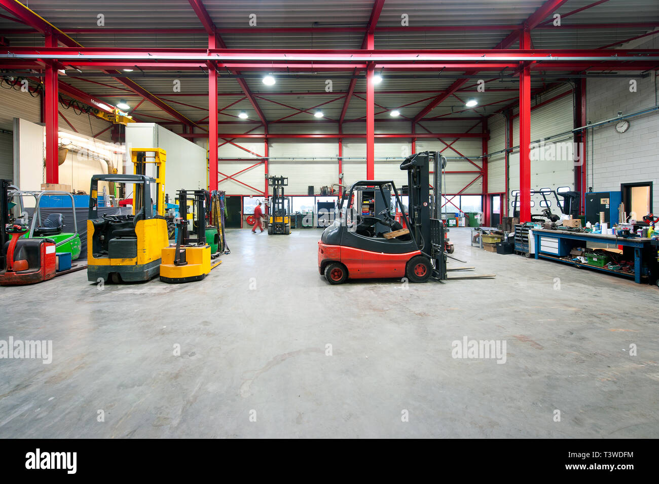 Forklift machinery working in warehouse Stock Photo - Alamy