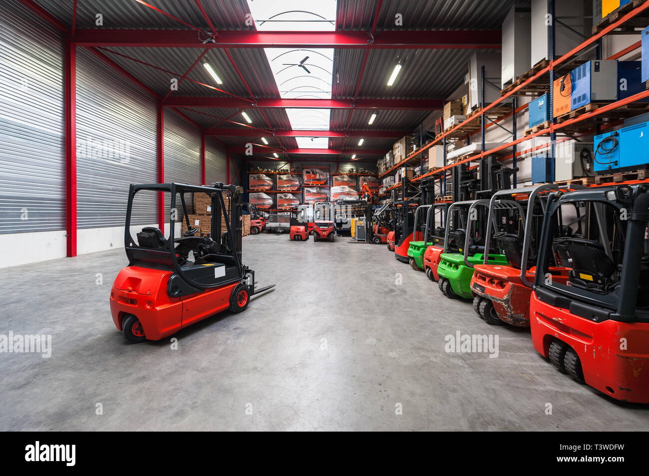 Forklift machinery working in warehouse Stock Photo - Alamy