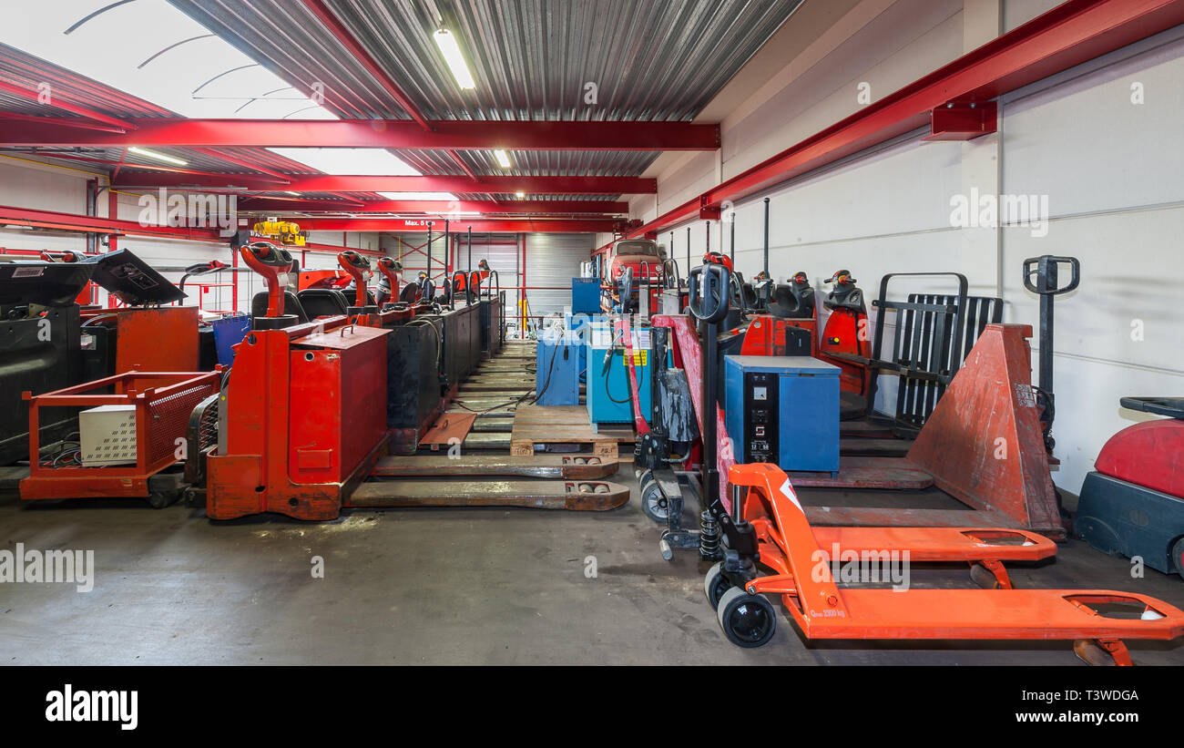 Machinery parked in warehouse Stock Photo - Alamy