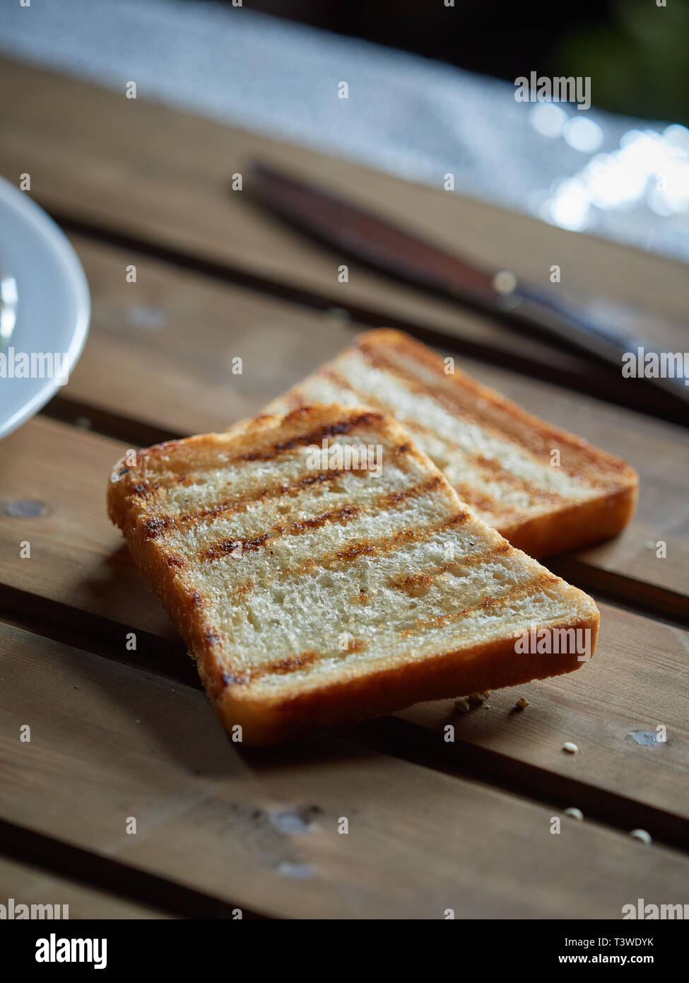 Slices of white bread are fried over an open fire Stock Photo - Alamy