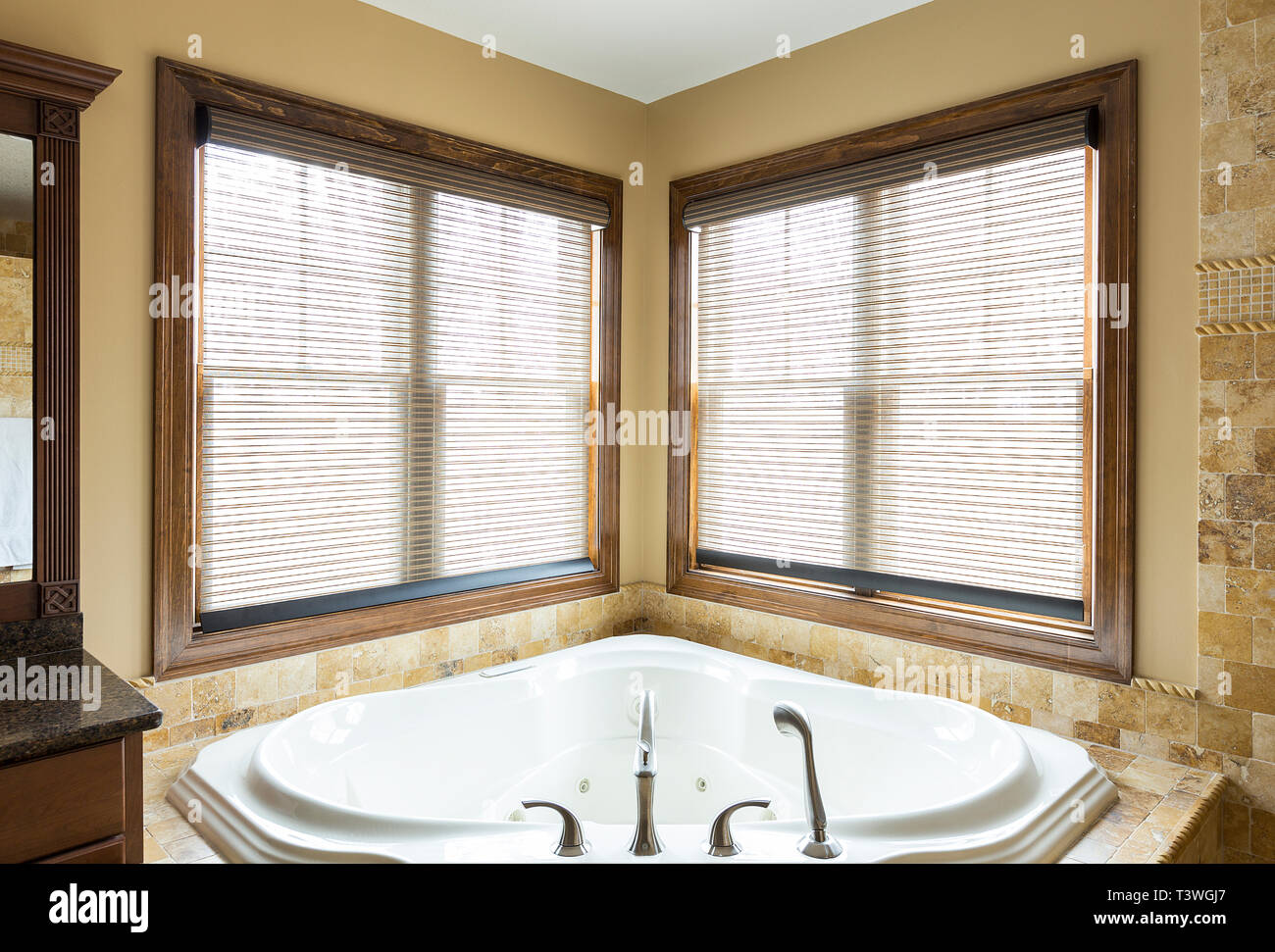 Luxury bathtub and windows in corner of modern bathroom Stock Photo - Alamy