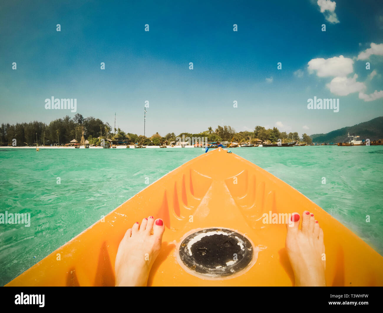 kayaking in crystal clear tropical waters - kayak heading to isolated ...
