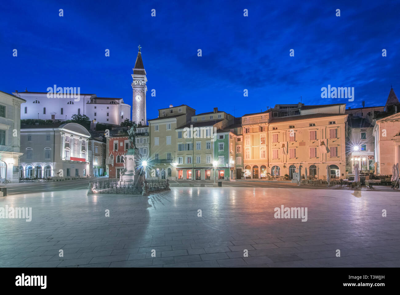 Town square, tower and buildings illuminated at night, Piran, Coastal ...
