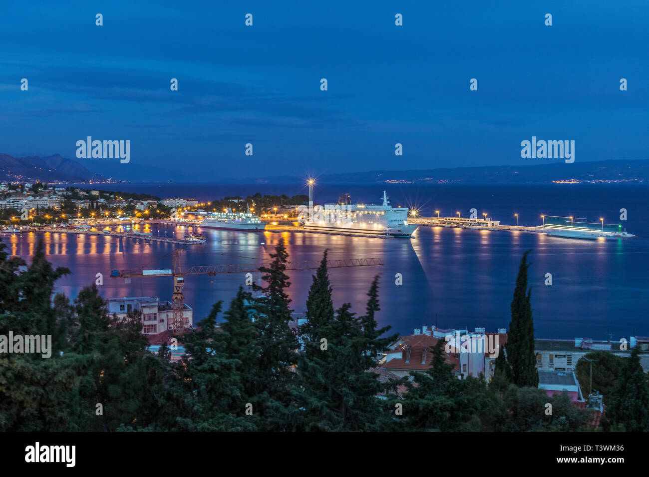 Aerial view of illuminated dock and cityscape of coastal town, Split ...
