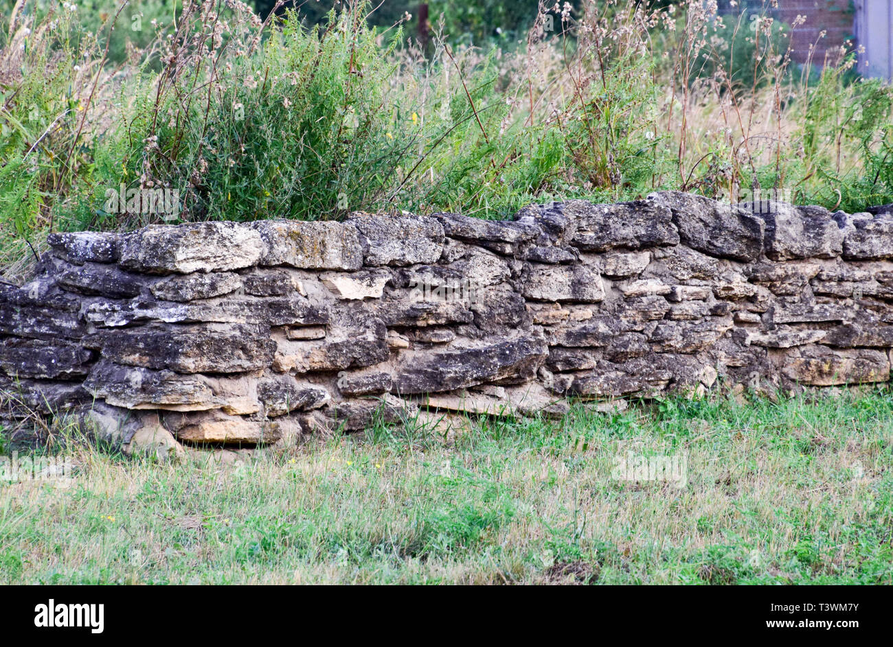 An old ruined wall made of rubble Stock Photo - Alamy