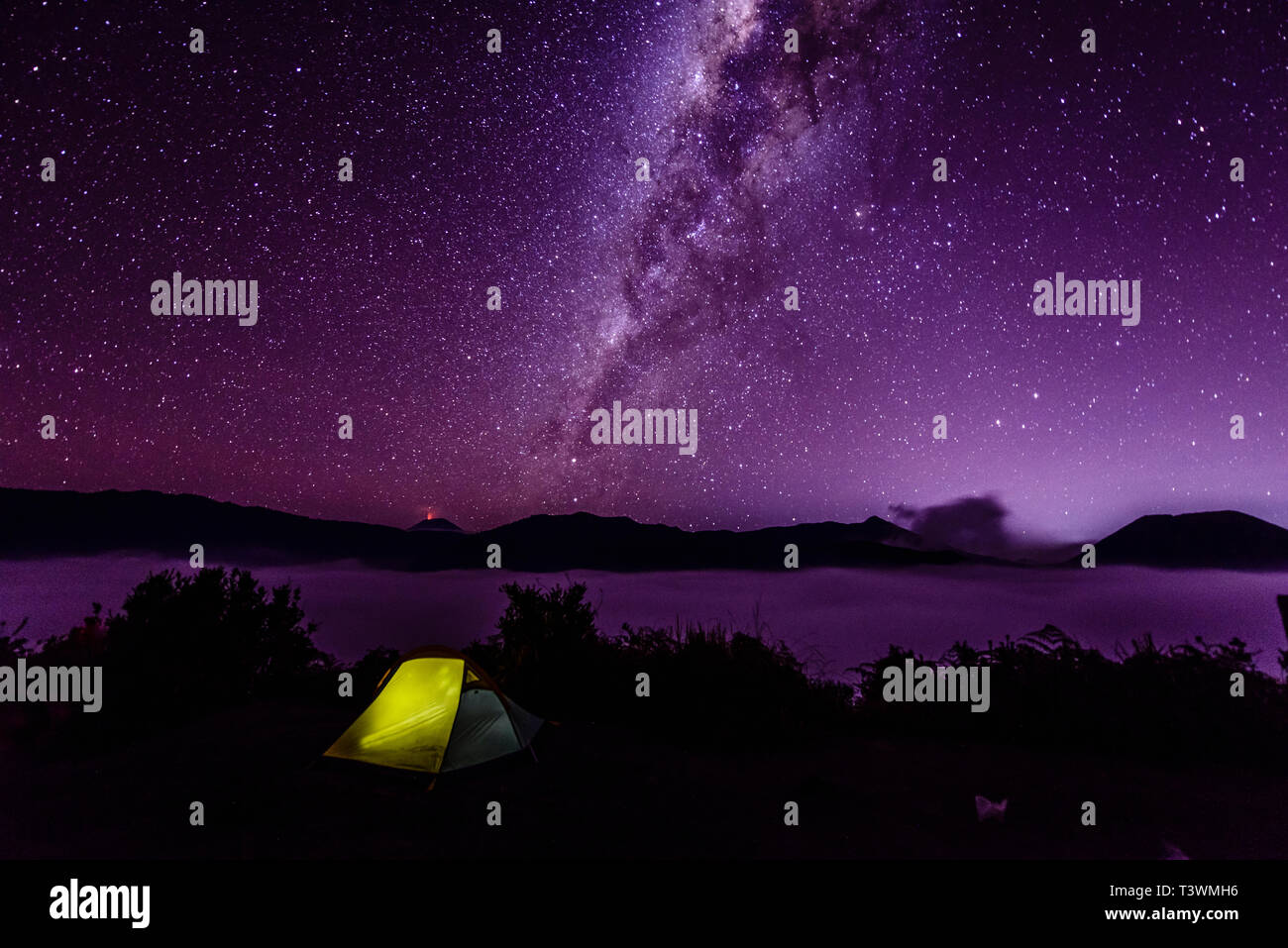 Milky Way galaxy over campsite in starry night sky Stock Photo - Alamy
