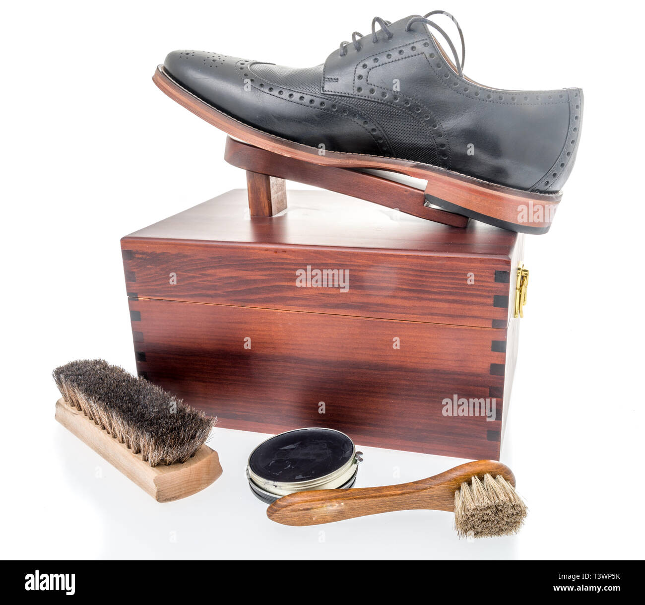 A black shoe on a shoe polish box that is ready to be shined with shoe ...