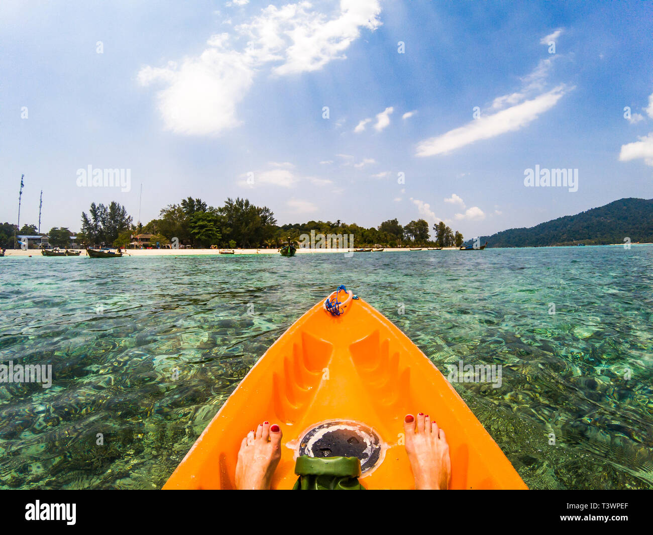 kayaking in crystal clear tropical waters - kayak heading to isolated ...