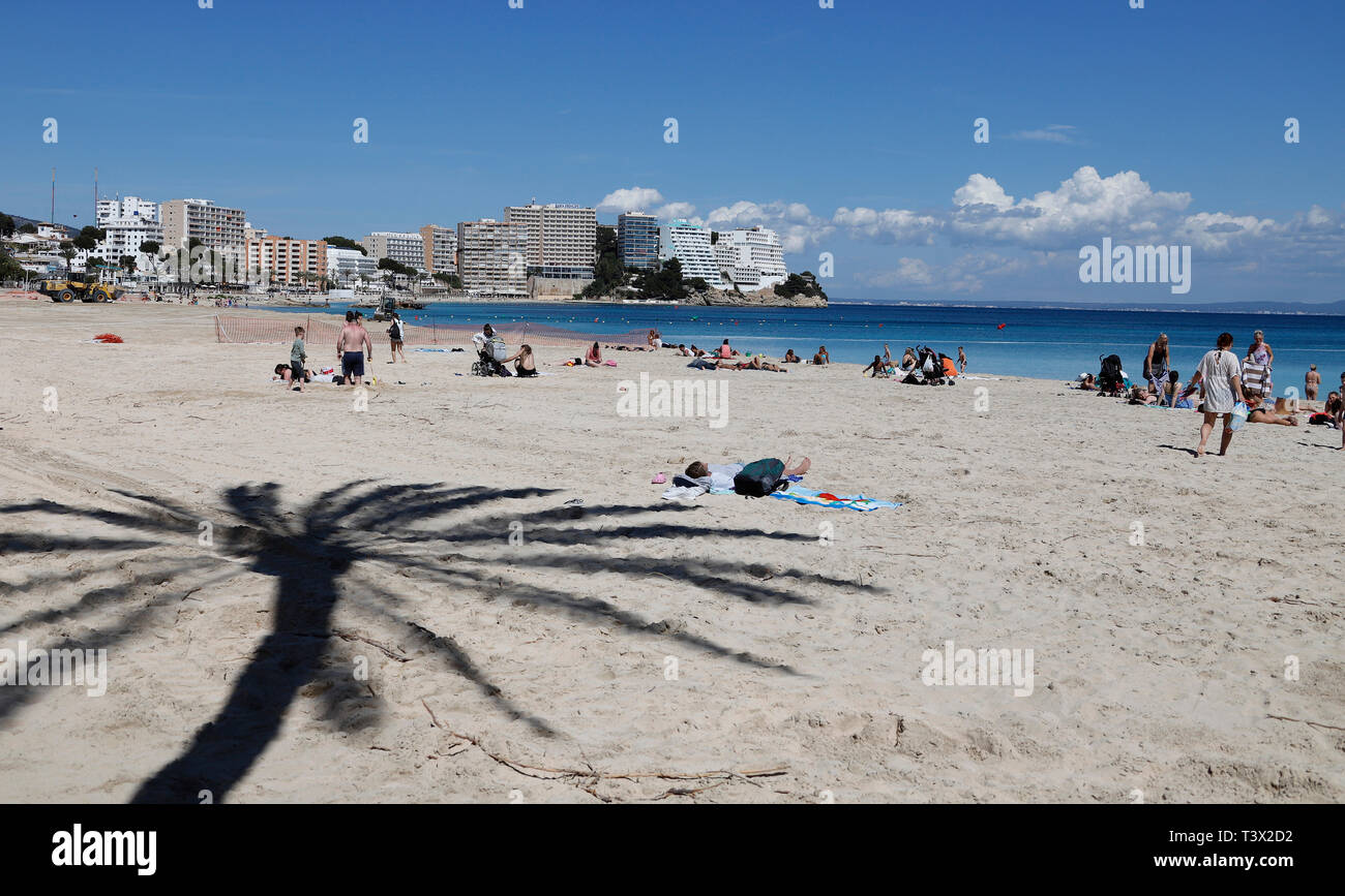 11 April 2019, Spain, Calvia: People sunbathe in Magaluf beach during a ...