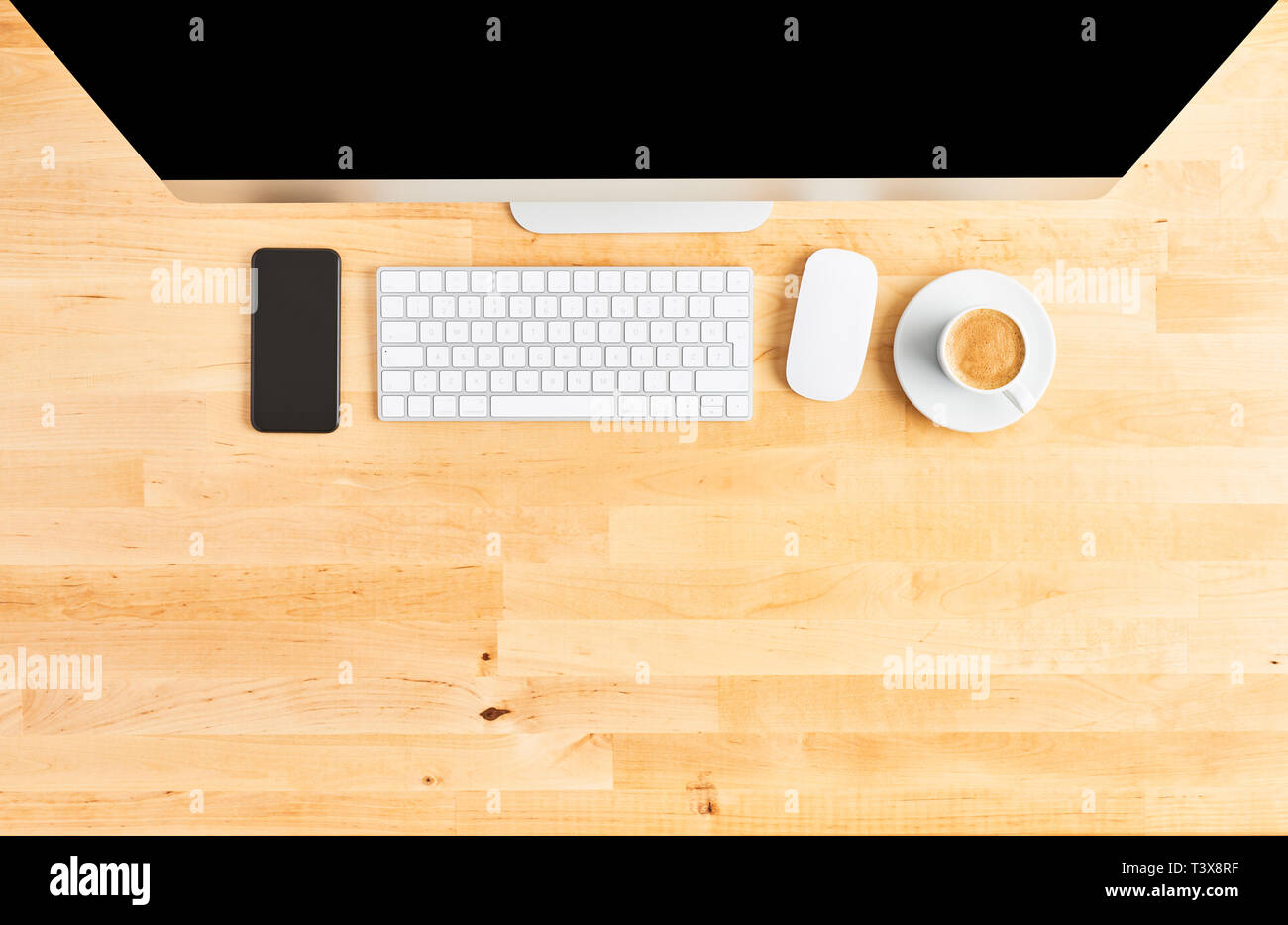 Modern desktop computer. Top view of wooden office desk with large ...