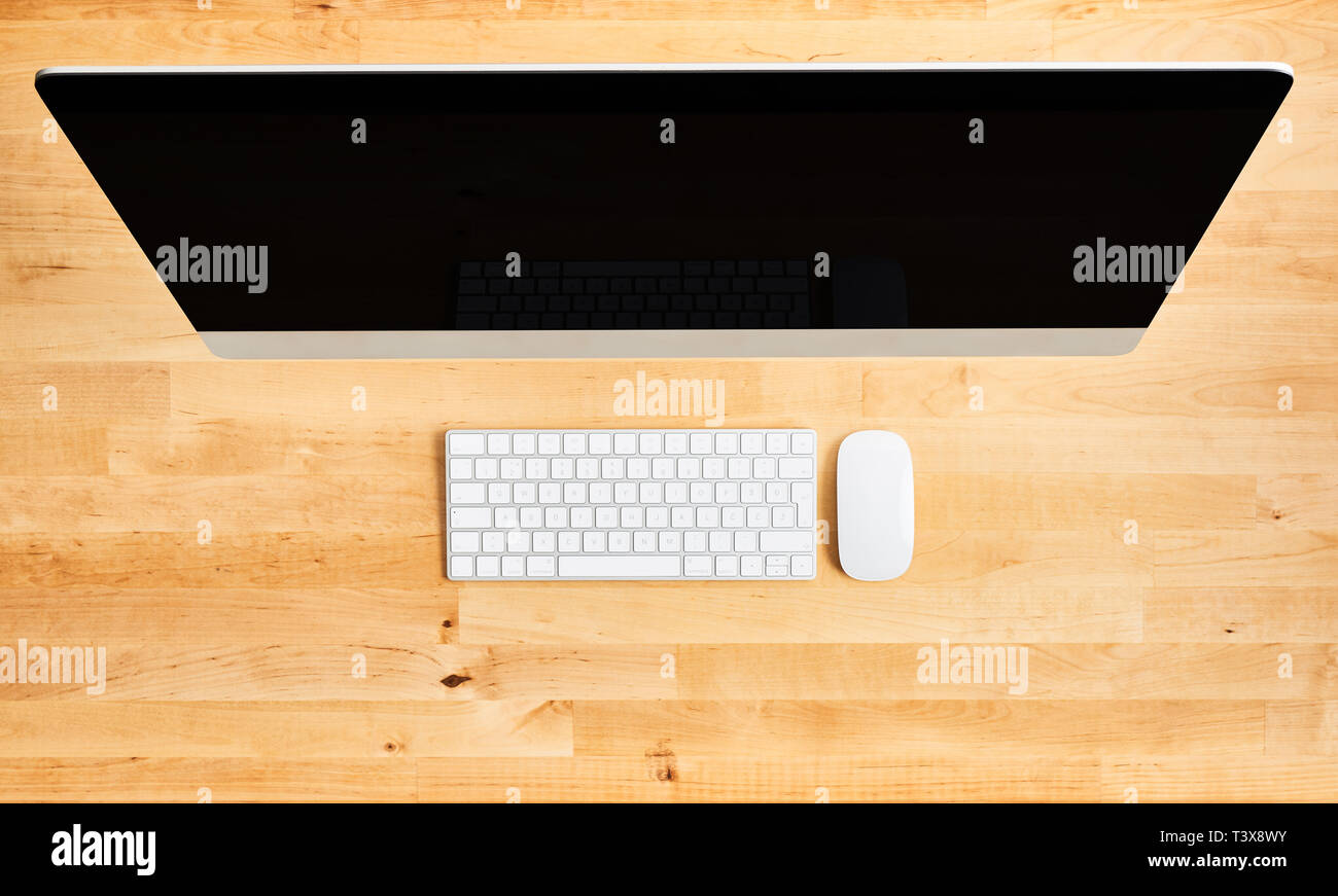 Desktop computer top view. Top view of wooden office desk with large ...