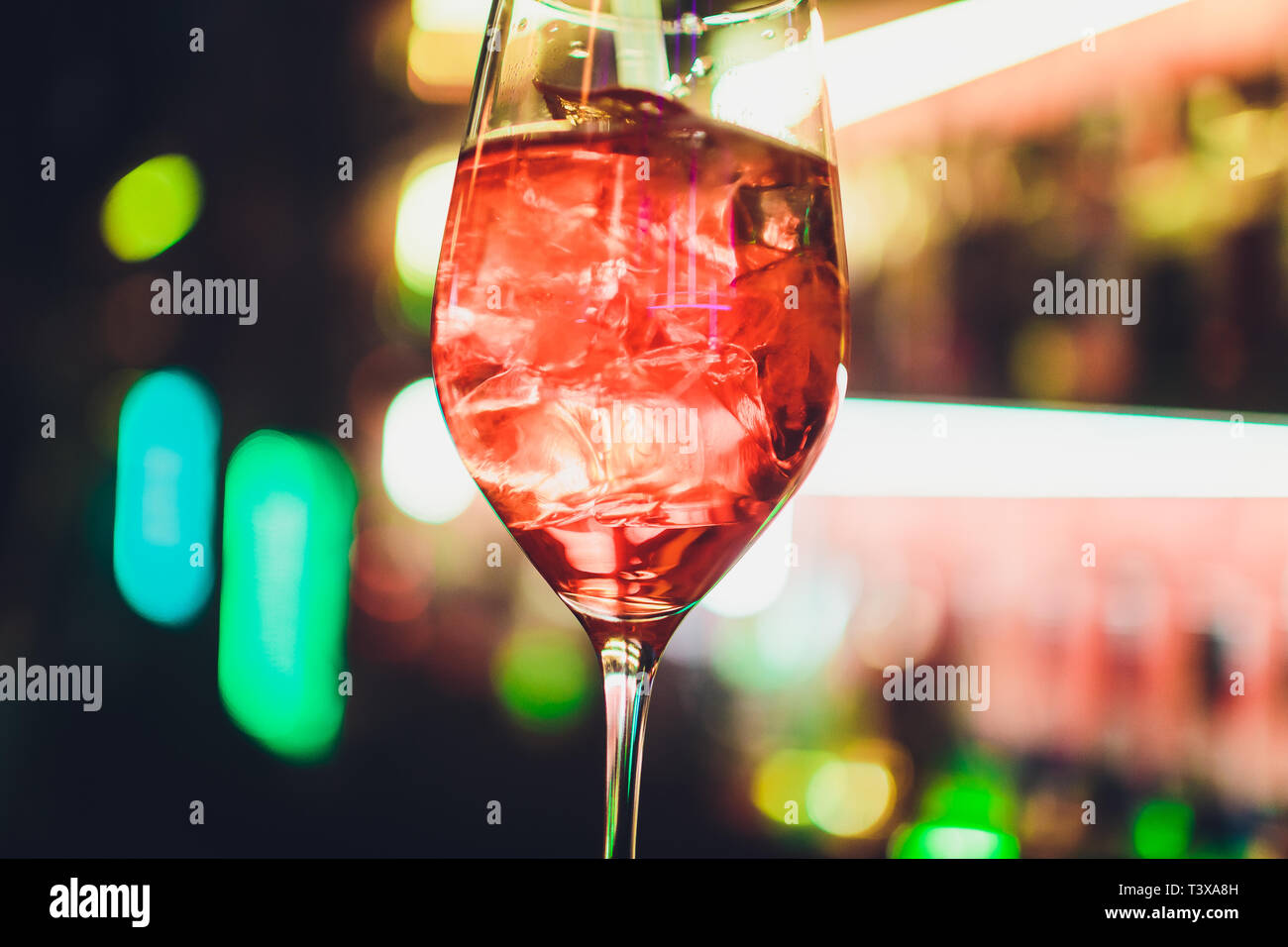 glasses of cocktails on the bar. bartender pours a glass of sparkling wine with Aperol Stock ...