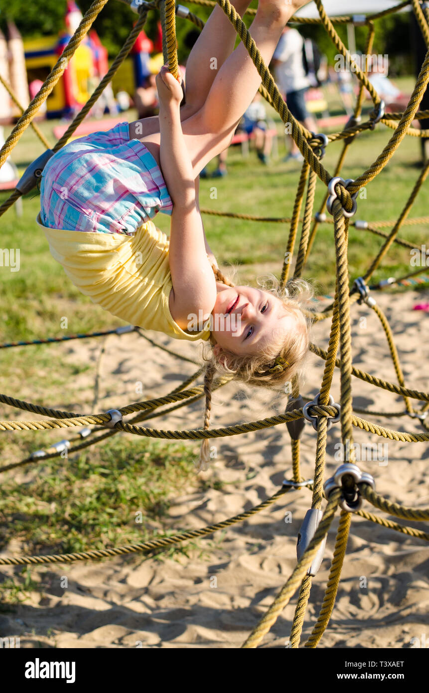 little girl playing in ropes in playground Stock Photo - Alamy