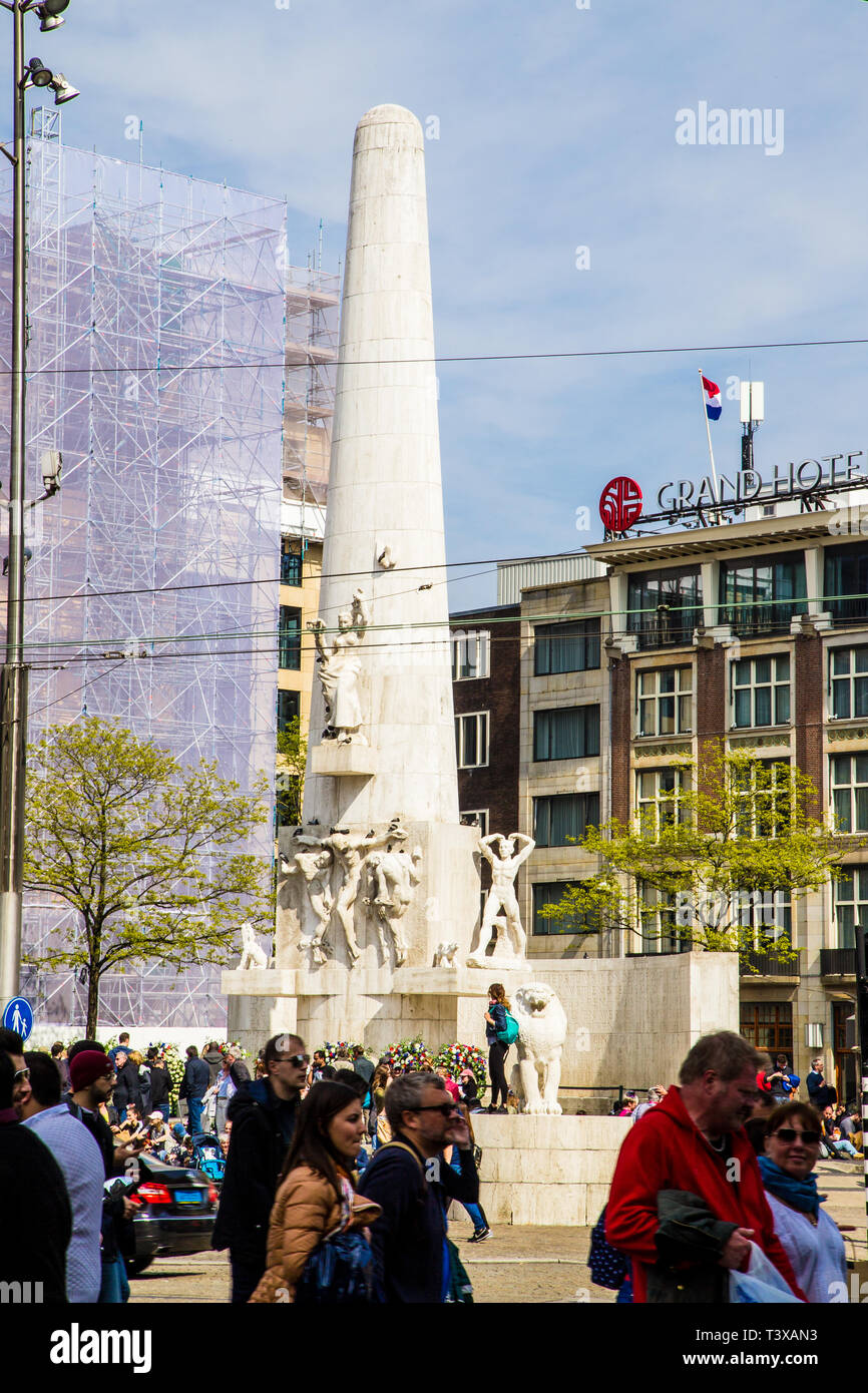 National Monument Dam Square, Amsterdam, Netherlands. people go about ...