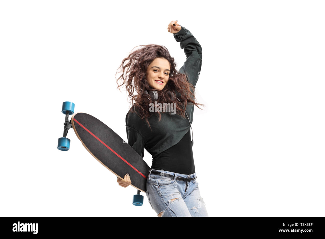 Happy teen girl with a longboard jumping isolated on white background ...